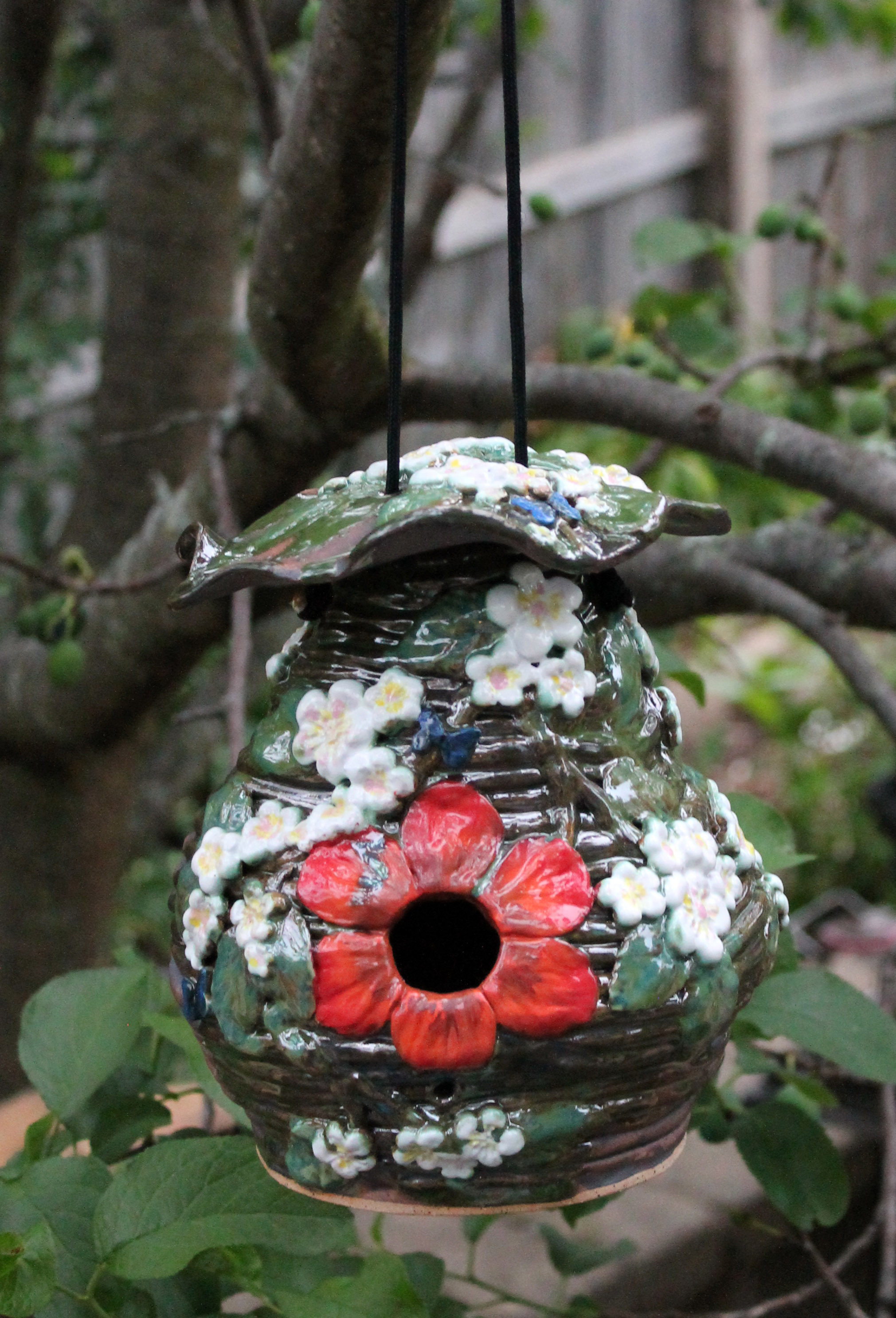 Cherry blossom and blue butterfly birdhouse hanging in tree ...